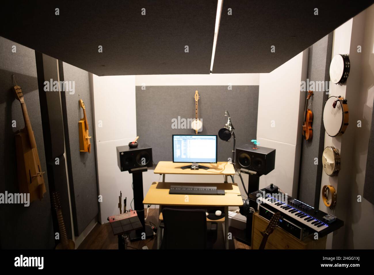 Music studio full of instruments and pc display Stock Photo - Alamy