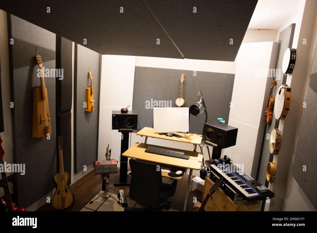 Music studio full of instruments and pc display Stock Photo - Alamy