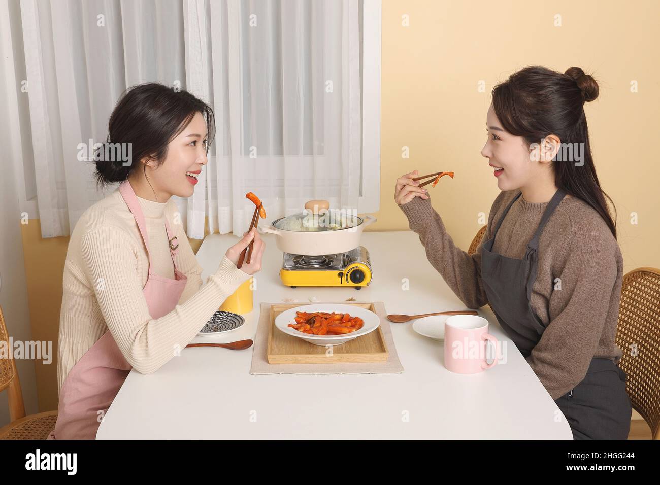 asian korean women eating after cooking together, spending time indoors ...