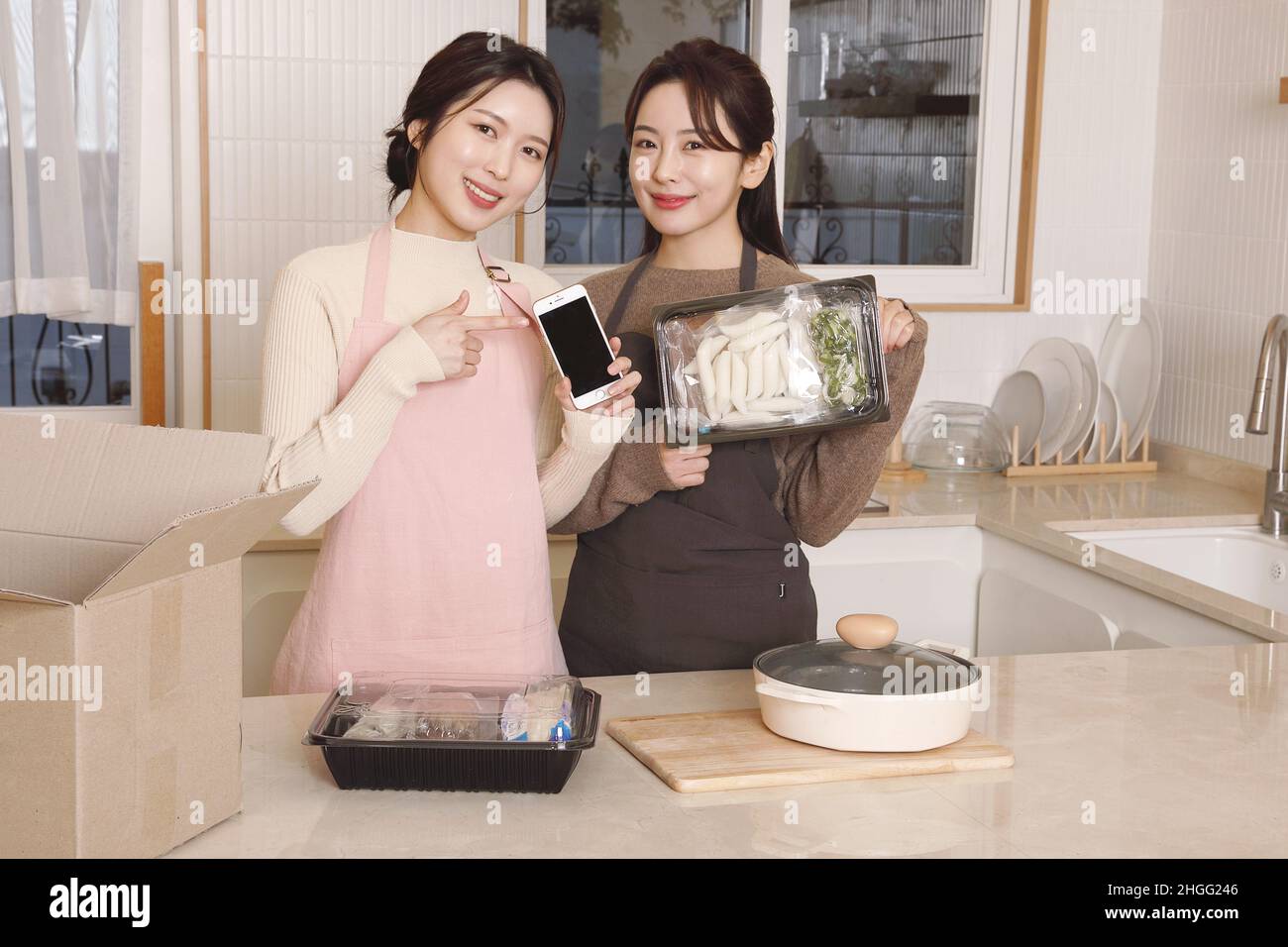 beautiful asian korean women cooking home meal kit Stock Photo - Alamy
