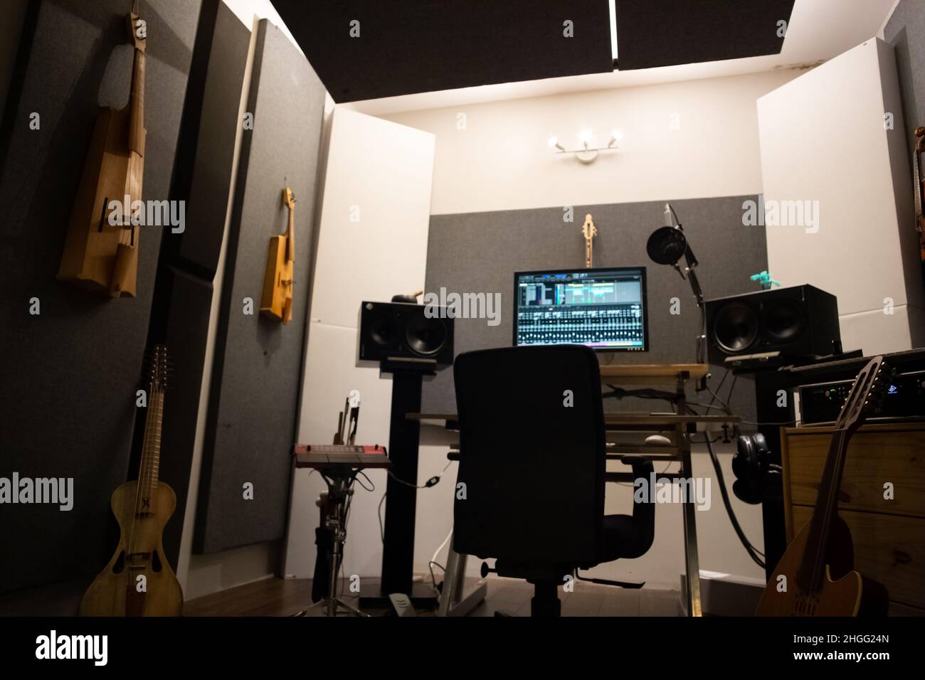 Music studio full of instruments and pc display Stock Photo - Alamy