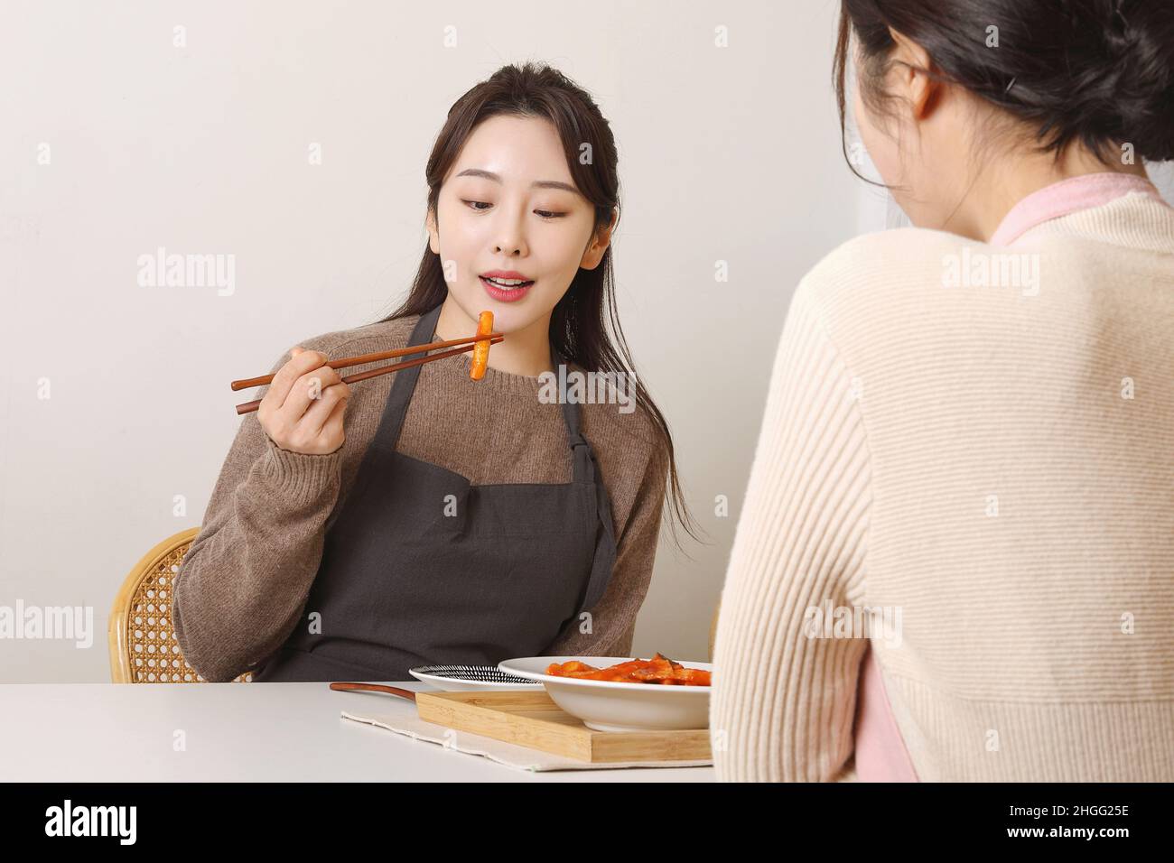 asian korean women eating after cooking together, spending time indoors ...