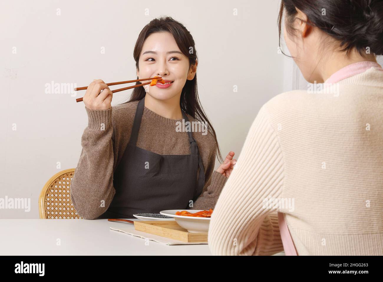 asian korean women eating after cooking together, spending time indoors ...