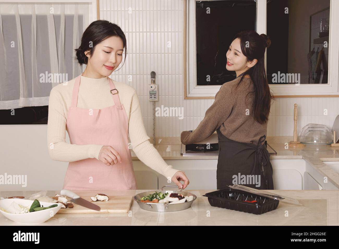 beautiful asian korean women cooking home meal kit Stock Photo - Alamy