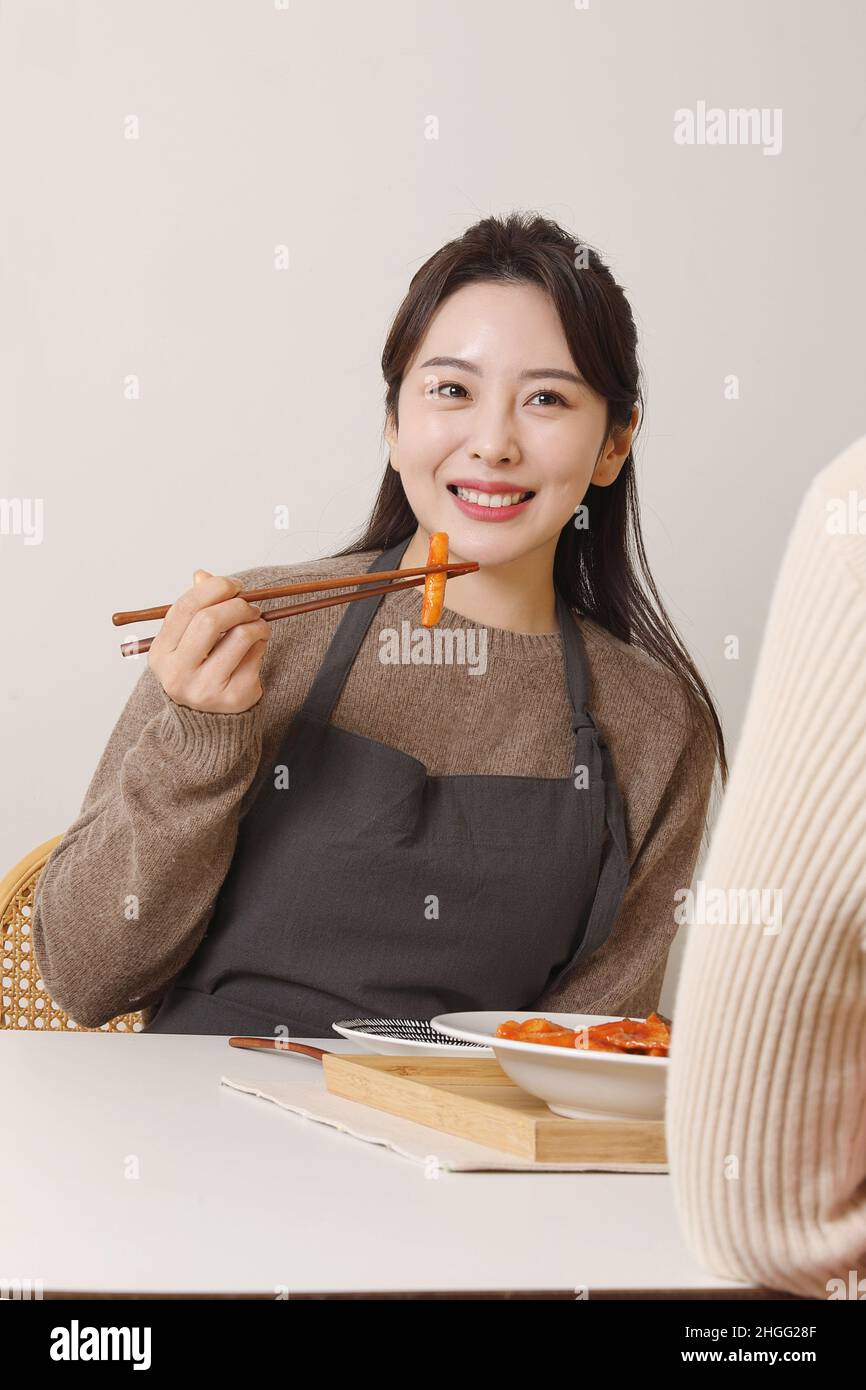 asian korean women eating after cooking together, spending time indoors ...