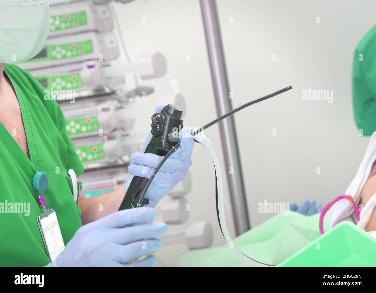 Male doctor holding endoscopic probe in gloved hands ready to start the ...