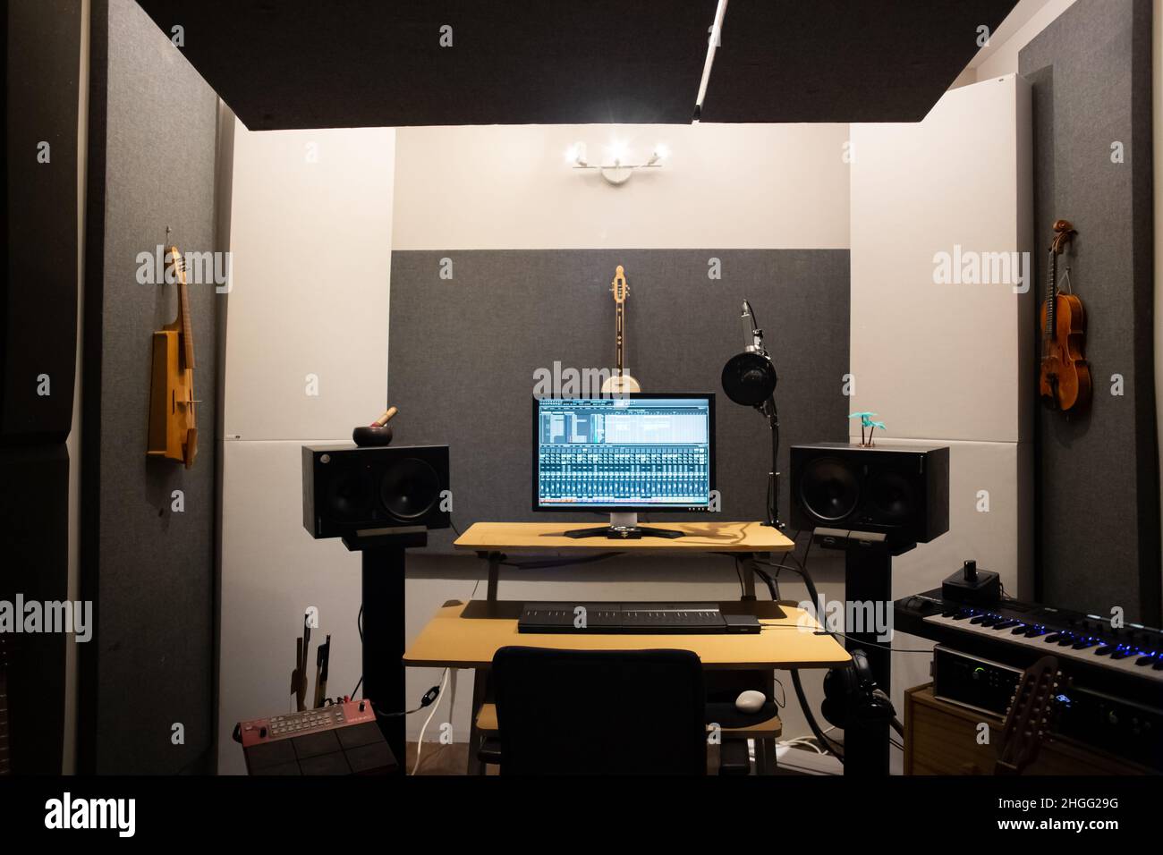 Music studio full of instruments and pc display Stock Photo - Alamy