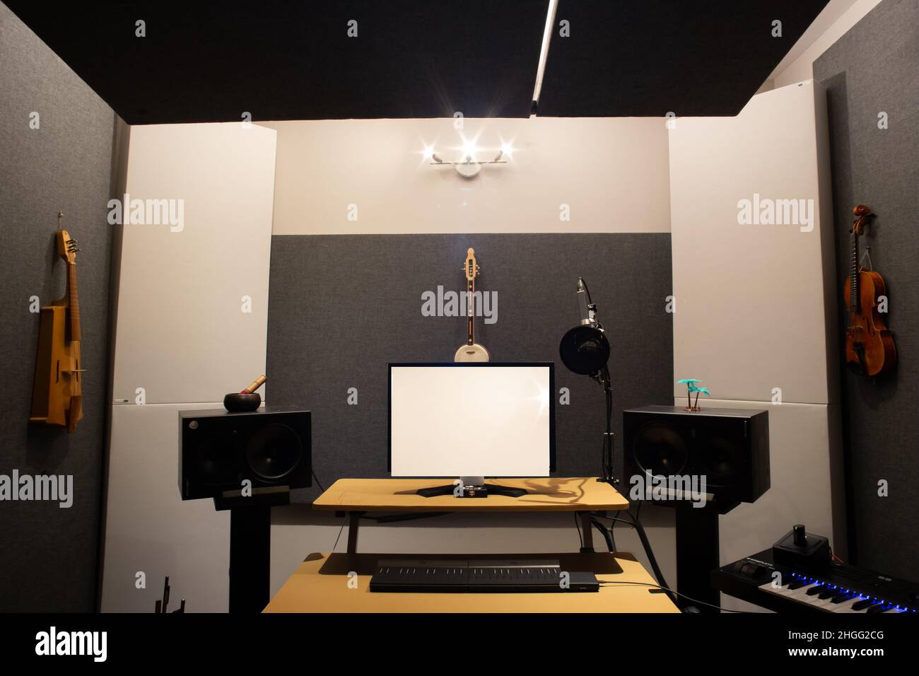 Music studio full of instruments and pc display Stock Photo - Alamy