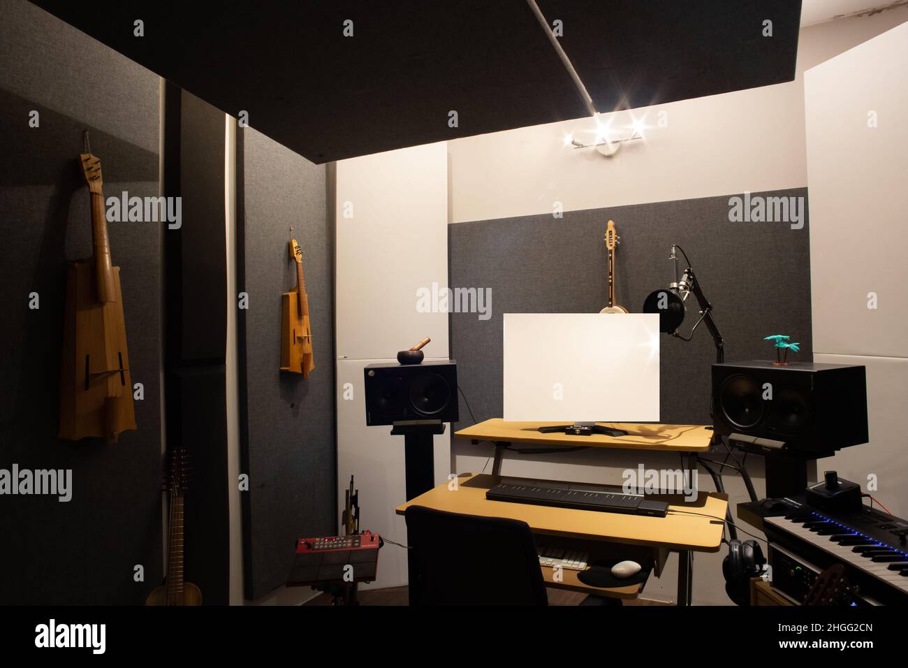 Music studio full of instruments and pc display Stock Photo - Alamy