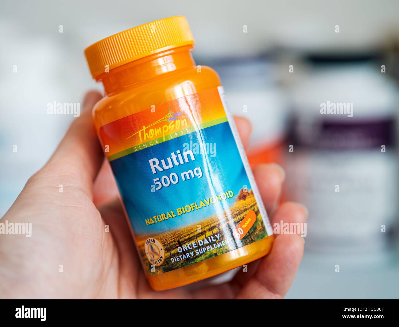 Moscow, Russia - March 09, 2021: Jar with rutin tablets in female hand ...