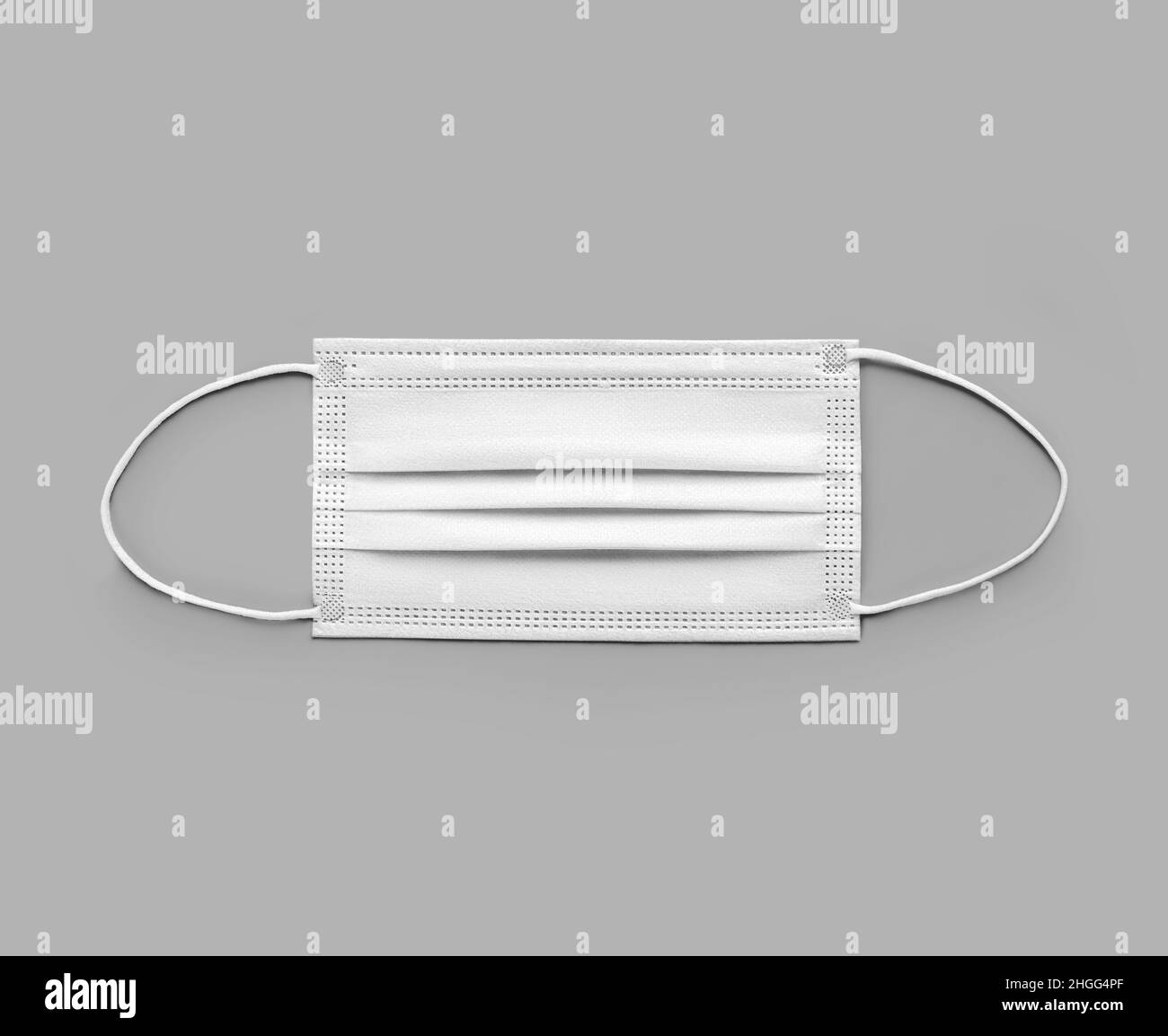 Mockup of a new white surgical mask with ear loops isolated on ...