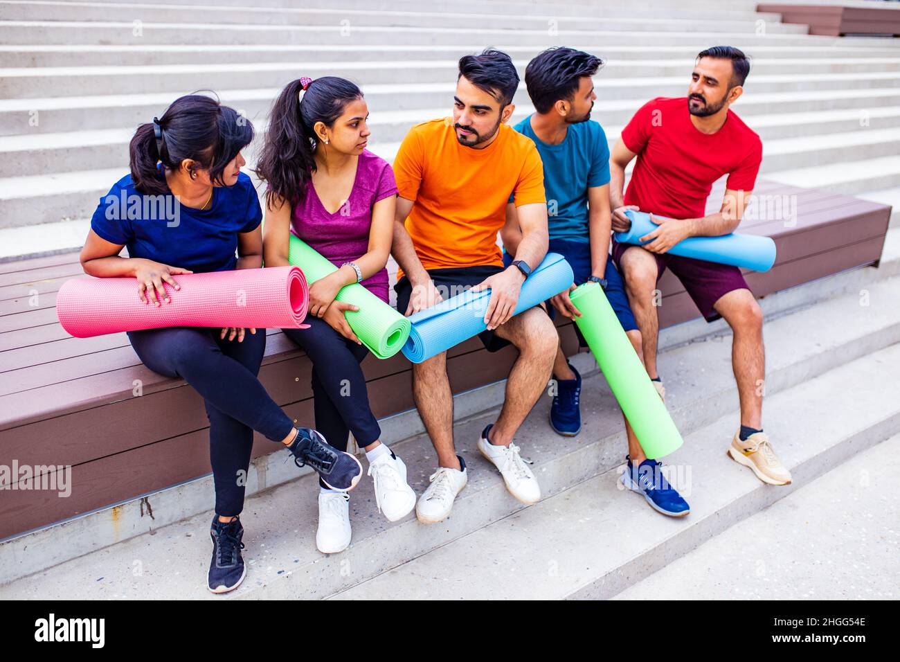 funny eastern ethnic people exercising together outdoor Stock Photo - Alamy