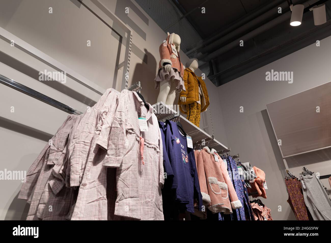 showcase with clothes in a store clothes for children and adults Stock ...