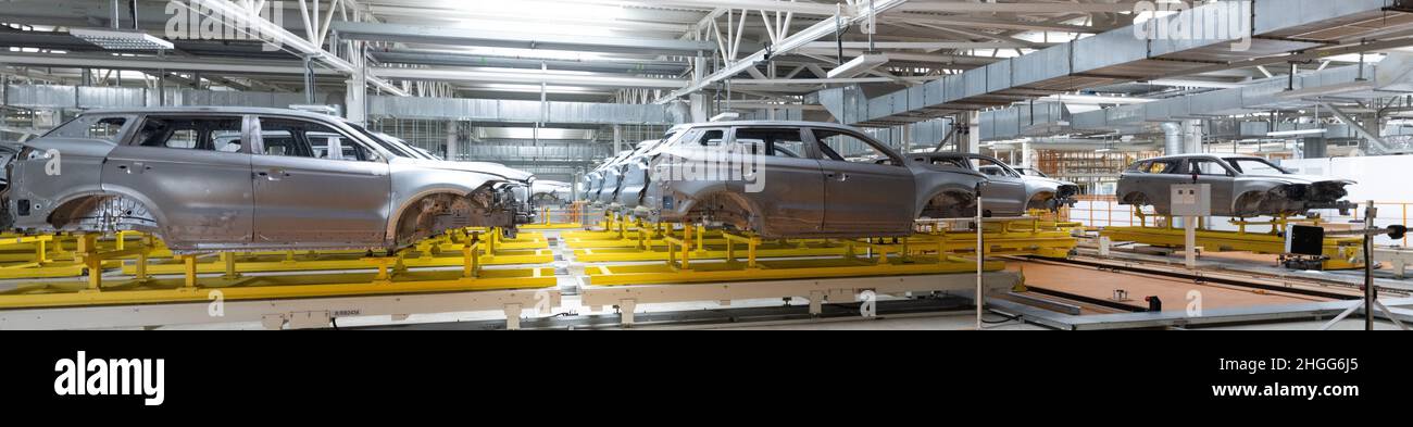 Panoramic photo of car bodies are on assembly line. Factory for ...