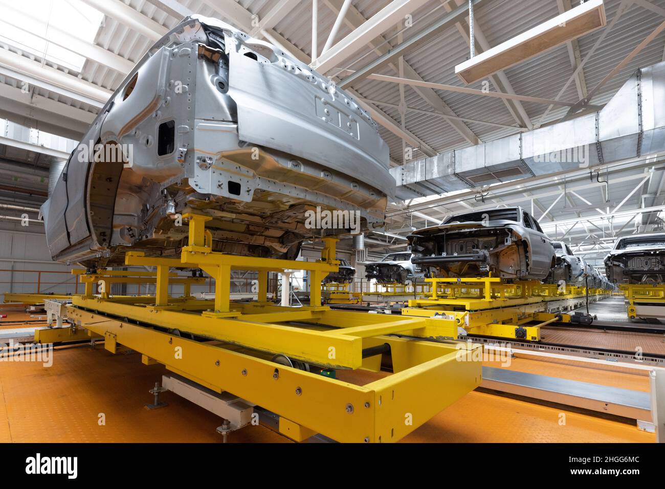 Car bodies are on assembly line. Factory for production of cars. Modern ...