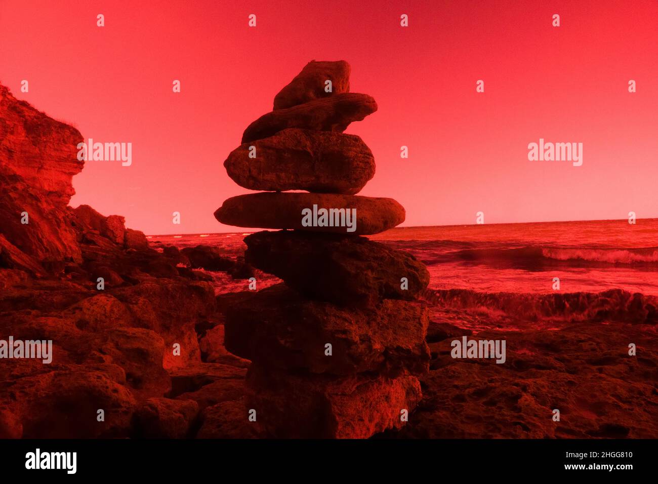 Pyramid of happiness. Flat stones are stacked by beachgoers on the ...