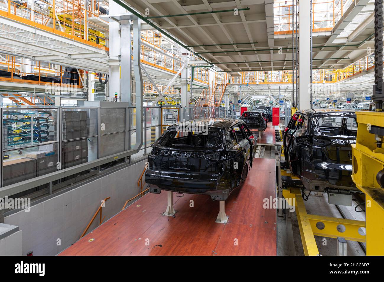 Car bodies are on assembly line. Factory for production of cars. Modern ...