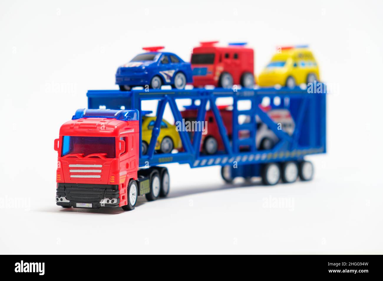 Toy car transporter with cars on a white background with place for text ...