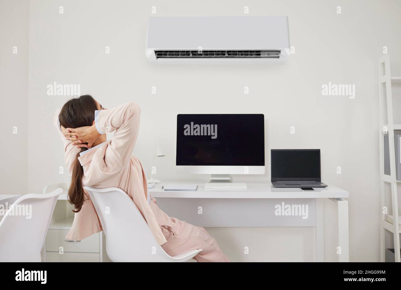 Woman relaxing during her break at work and breathing fresh air from ...