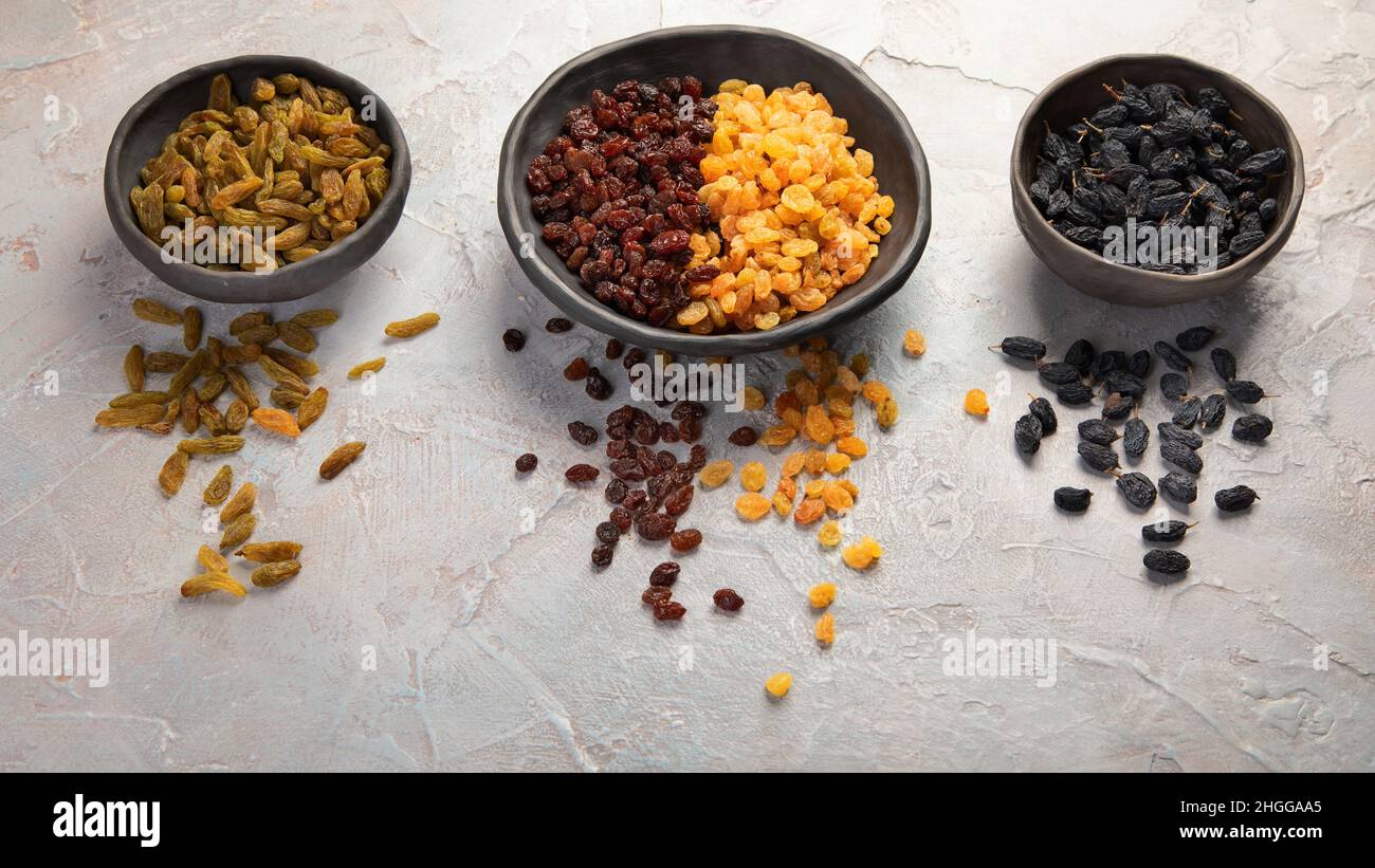 Different types of raisins on light backgroound. Dried Fruits. Top view ...
