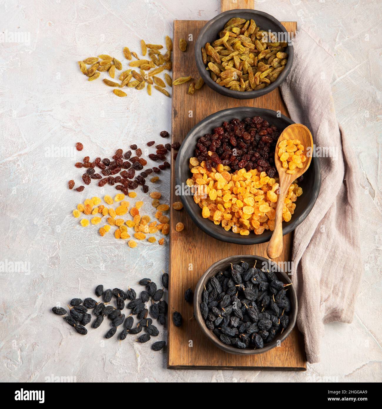 Different types of raisins on light backgroound. Dried Fruits. Top view ...