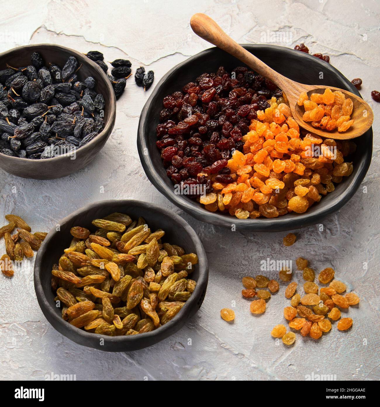Different types of raisins on light backgroound. Dried Fruits. copy ...