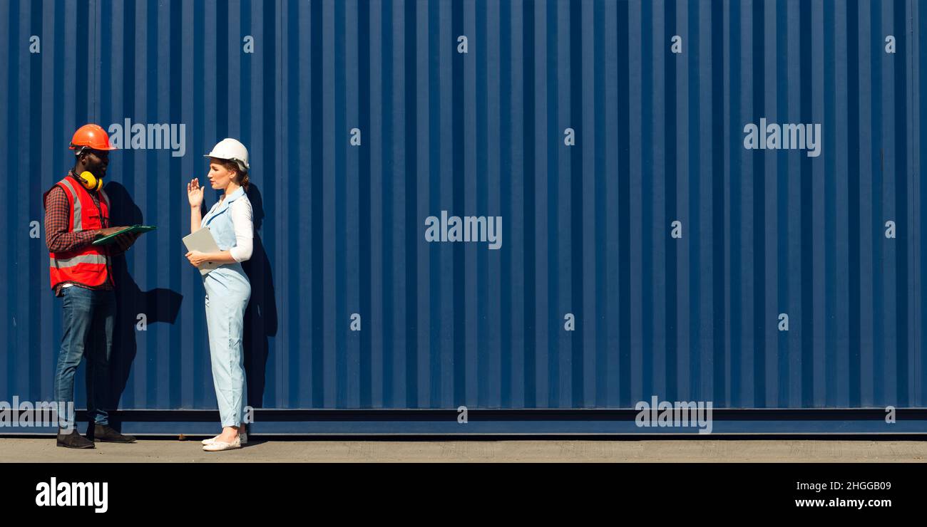 Businesswoman and engineer talking and checking loading Containers box ...