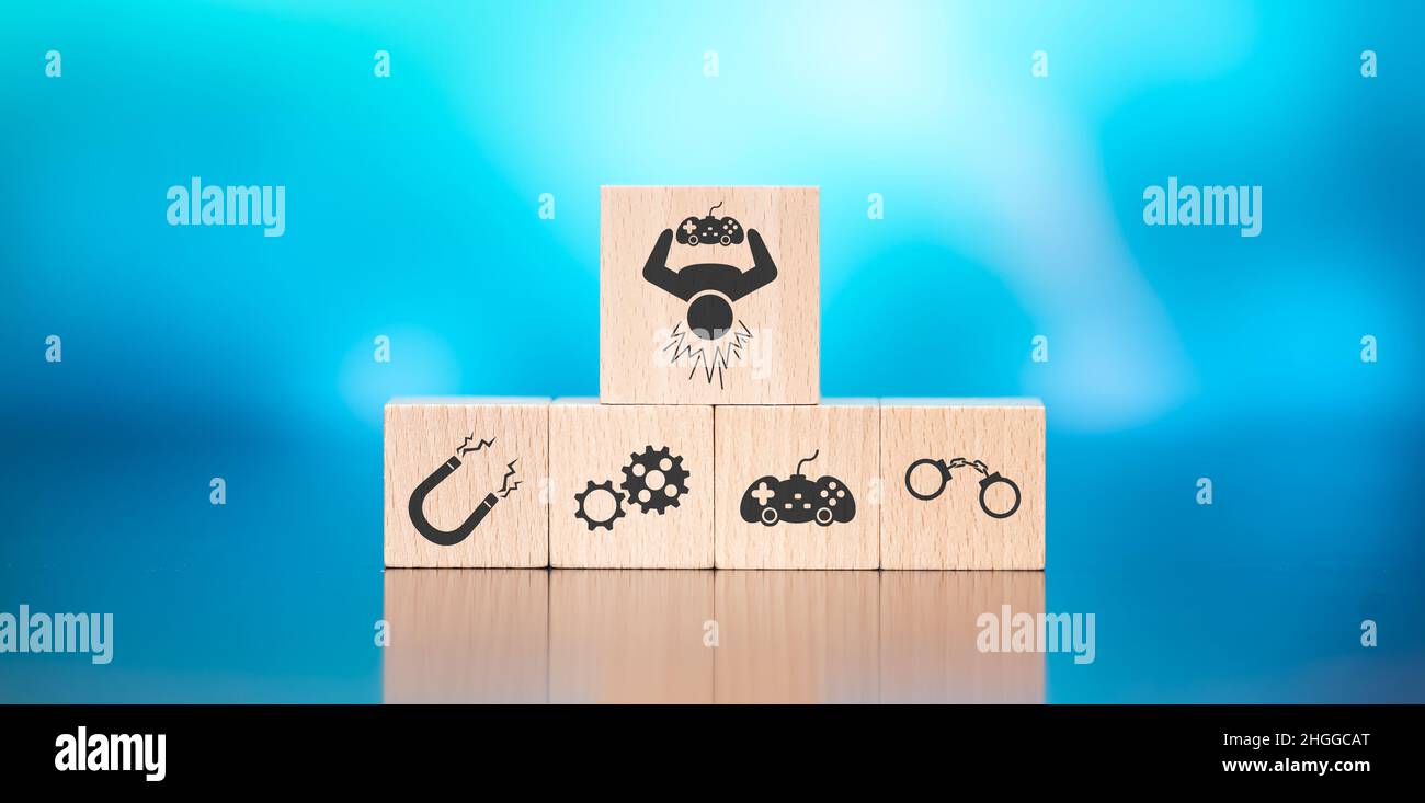 Wooden blocks with symbol of video game addiction concept on blue ...