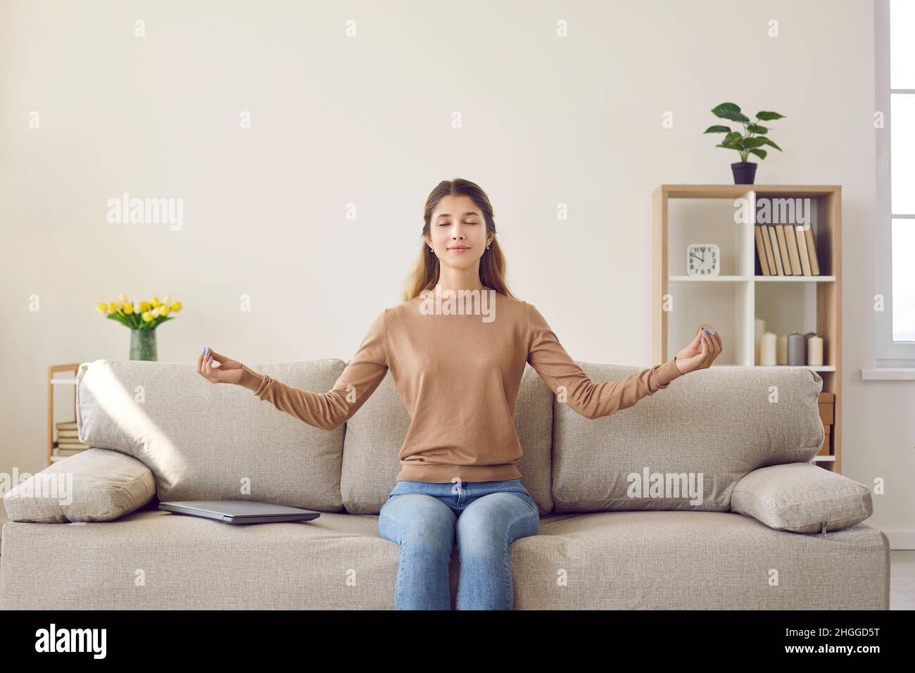 Portrait of young calm casual woman relaxing and meditating sitting on ...