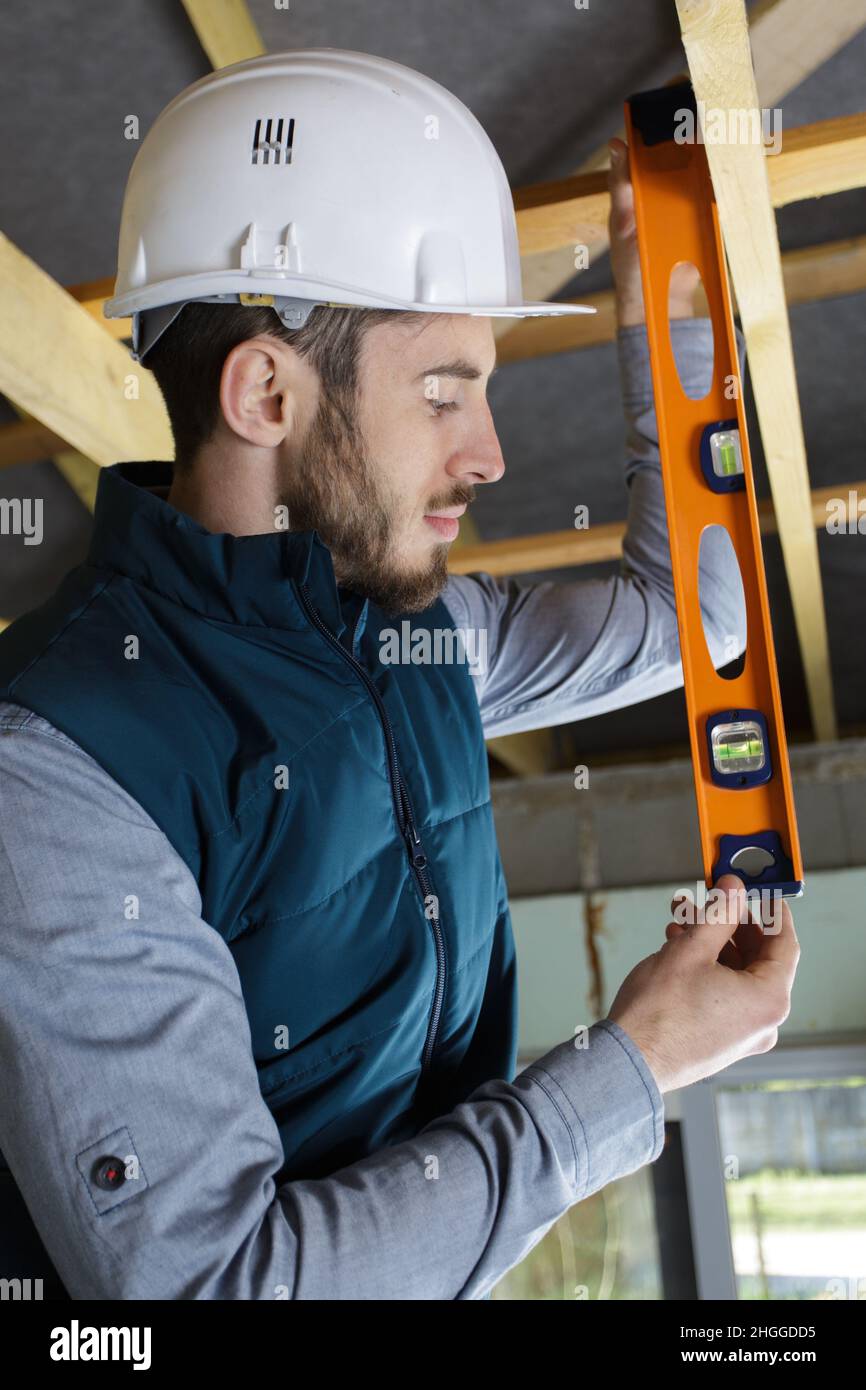 happy construction worker using a bubble level Stock Photo - Alamy