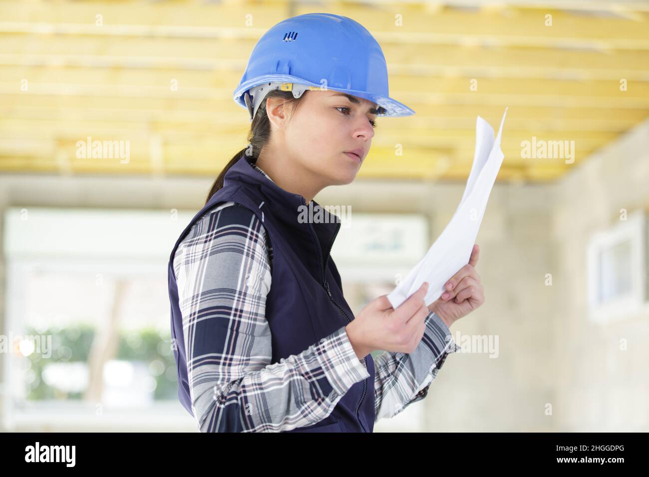 female construction site engineer holding blueprint Stock Photo - Alamy