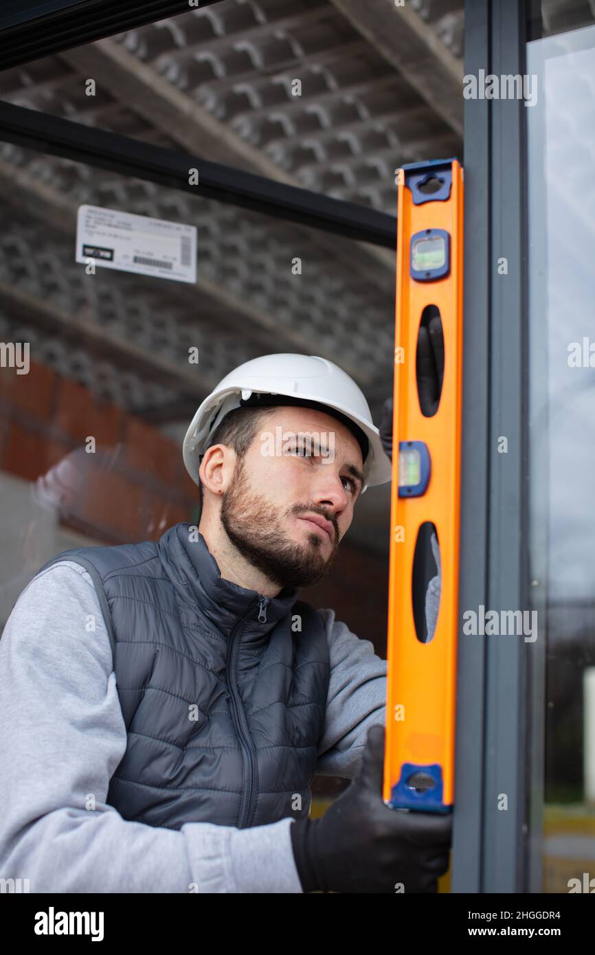 construction worker using spirit level in a new house Stock Photo - Alamy
