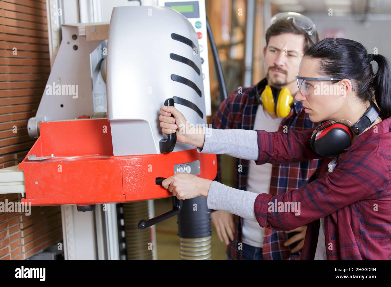 carpenter teaching apprentice how to cut wood Stock Photo - Alamy
