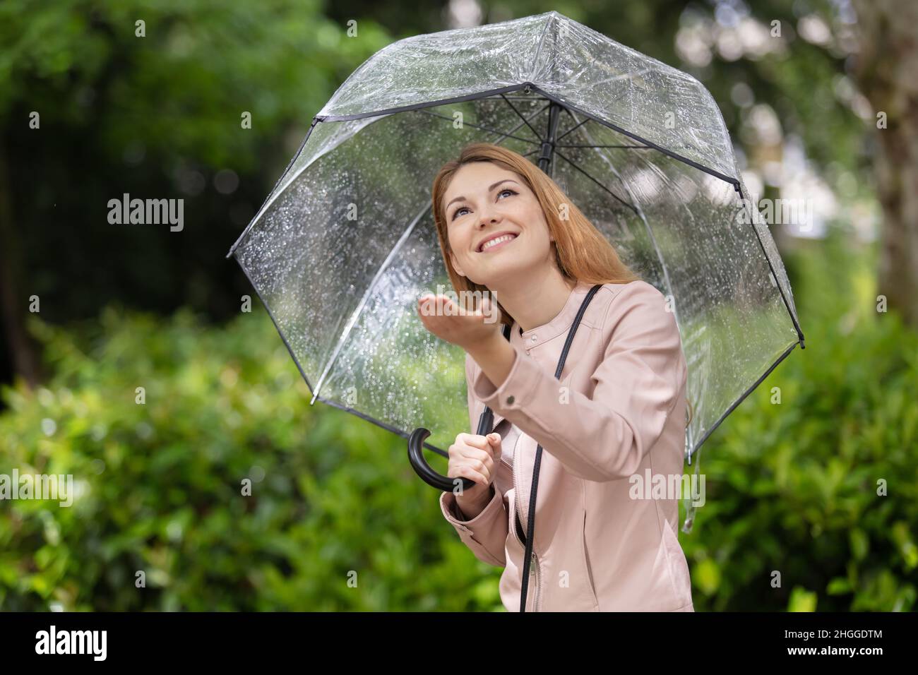 girl with umbrella catching raindrops during summer day Stock Photo - Alamy