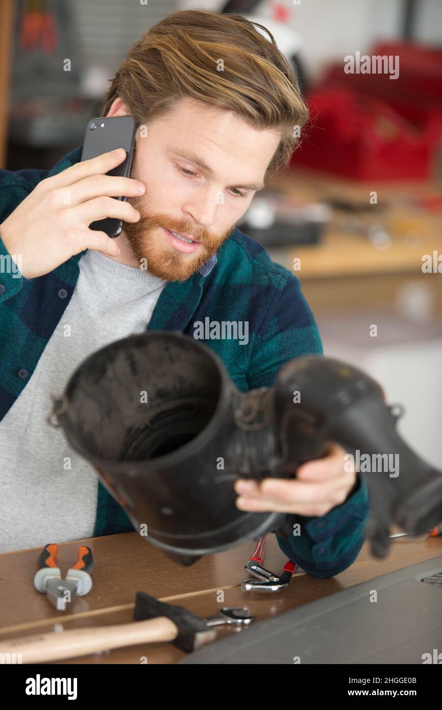 man holding mechanical part and quoting reference to order replacement ...