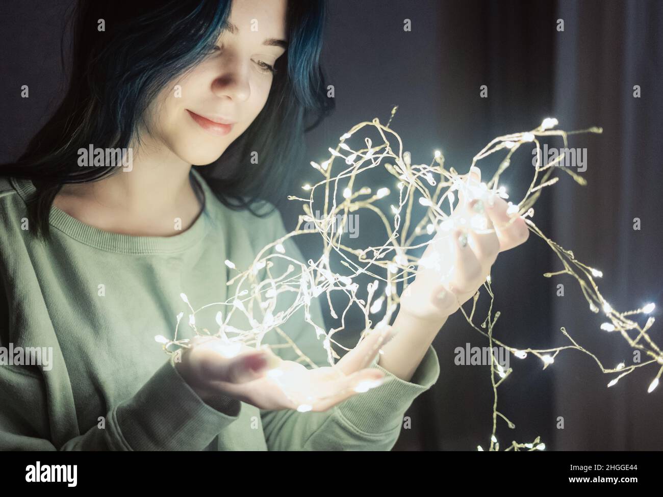 Beautiful teenager girl with light garland at home. Night scene Stock ...