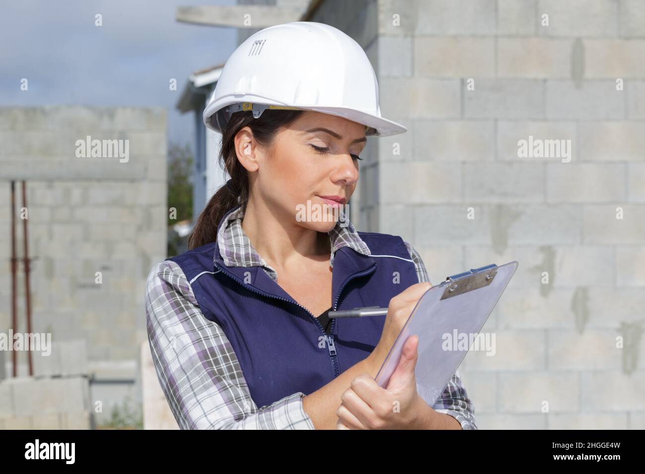 woman builder taking notes at construction site Stock Photo - Alamy
