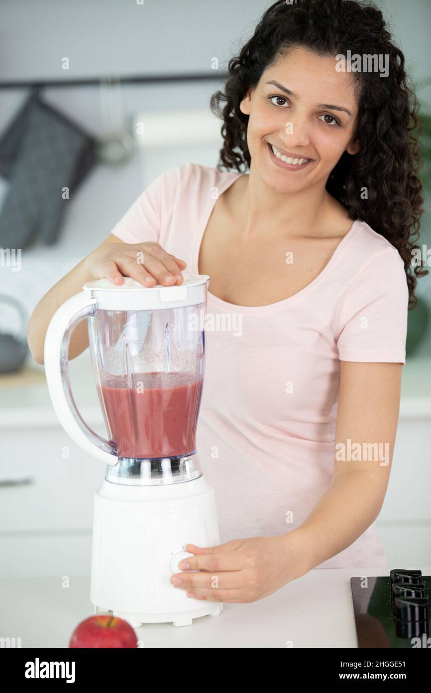 happy woman mixing fruit in blender Stock Photo - Alamy