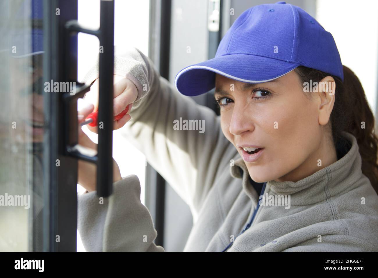 woman making an expression of effort using screwdriver Stock Photo - Alamy