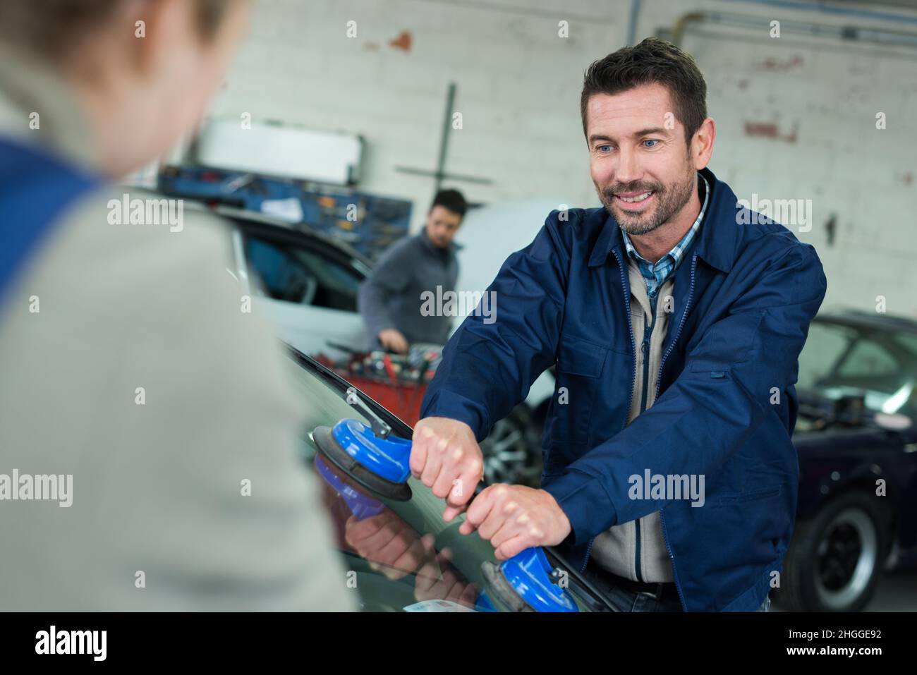 workers mending car windshield Stock Photo - Alamy