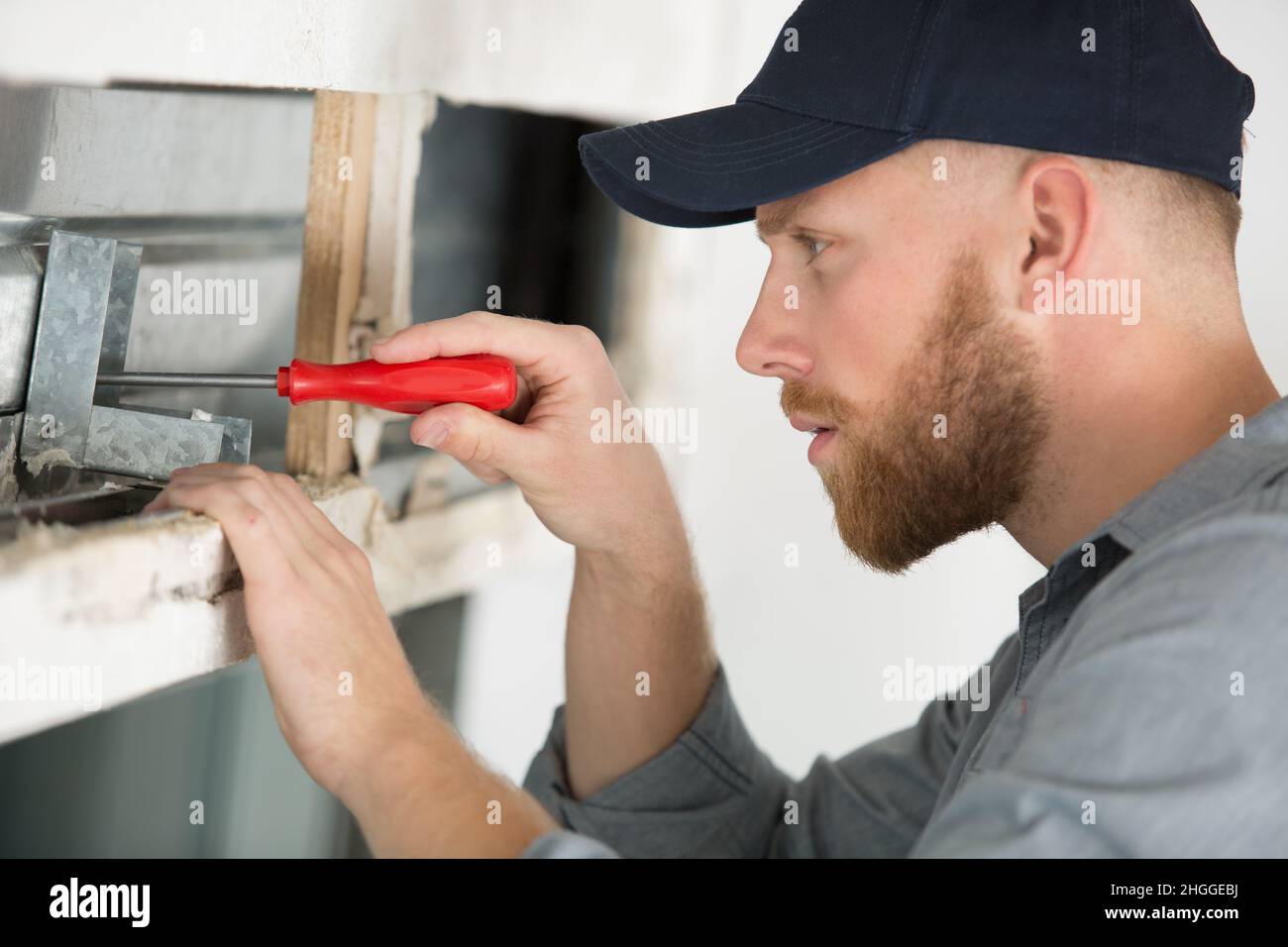 carpenter working with metal window Stock Photo - Alamy