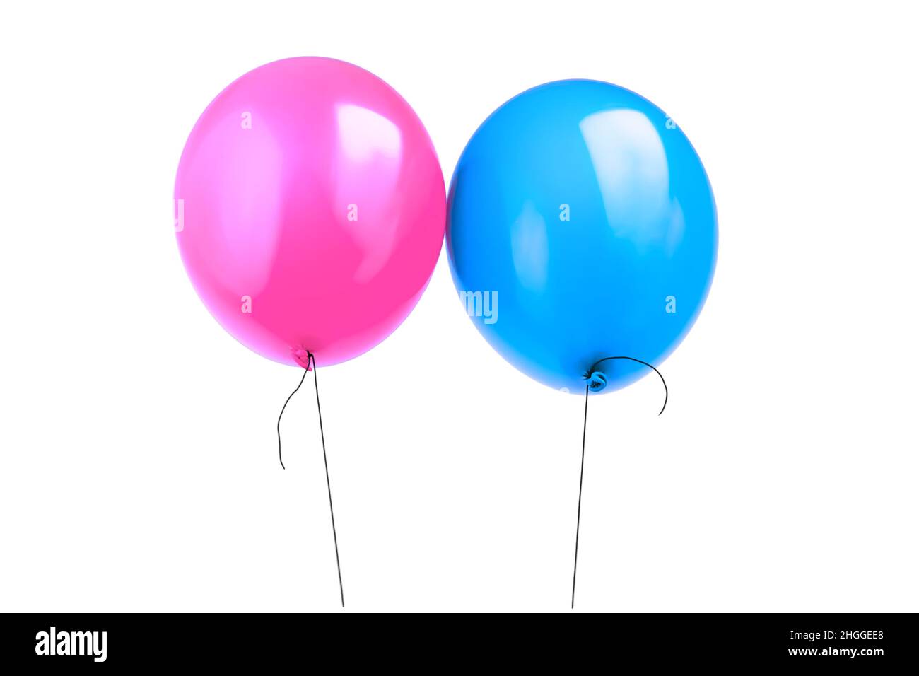 Pink and blue balloons inflated with helium float in the air. concept ...