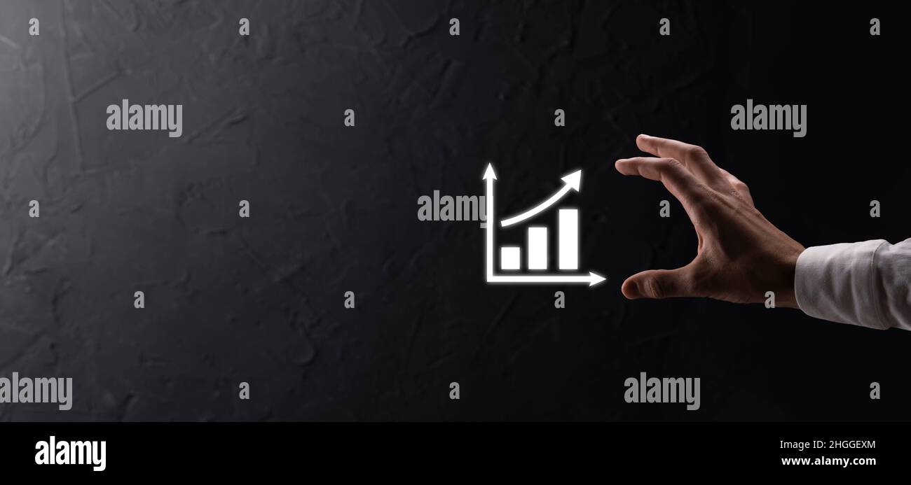 Businessman man holding a graph with positive profits growth. plan ...