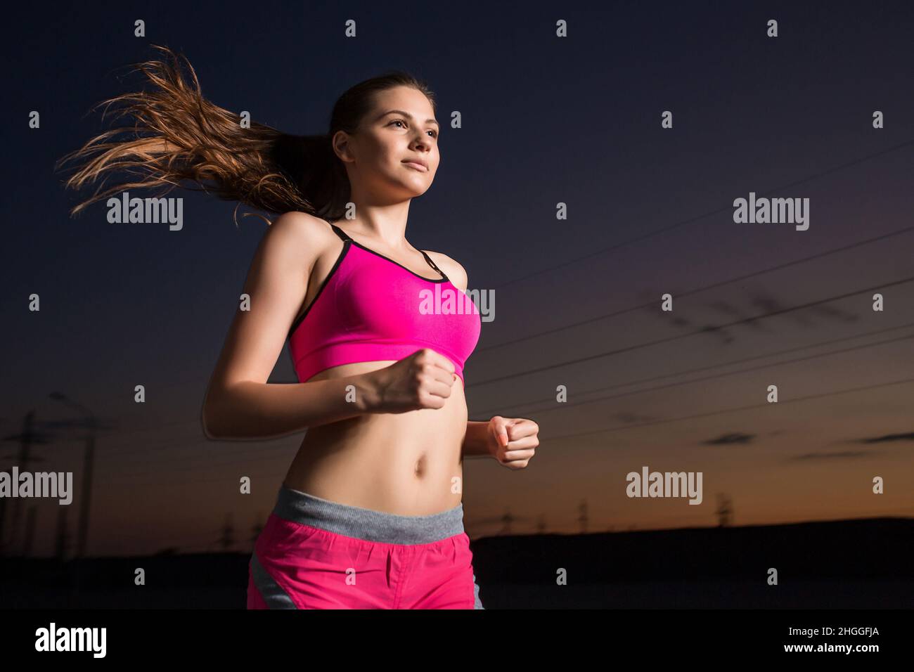 Running woman. Runner jogging in evening Stock Photo - Alamy