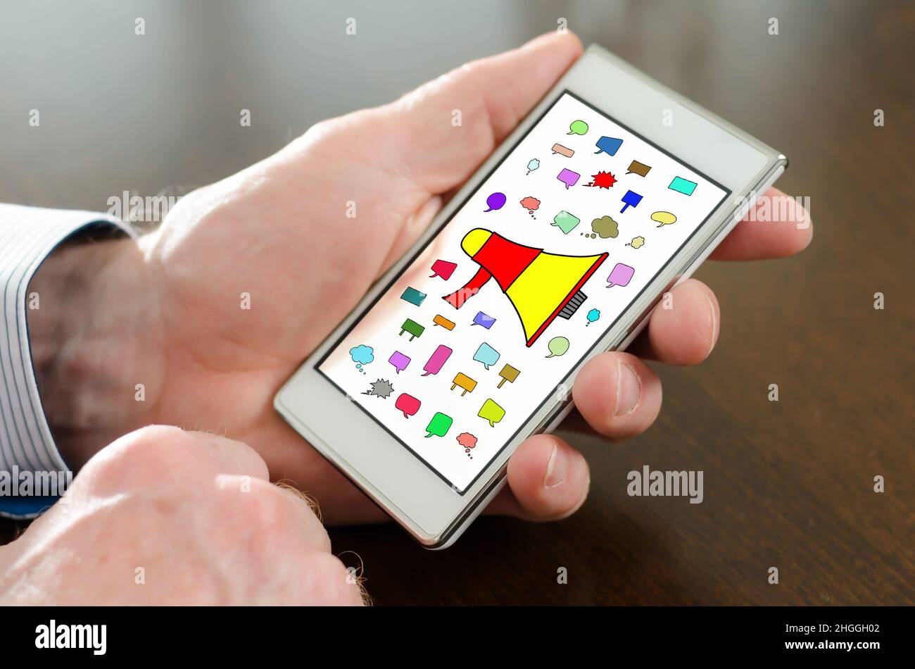 Hand holding a smartphone with communication concept Stock Photo - Alamy