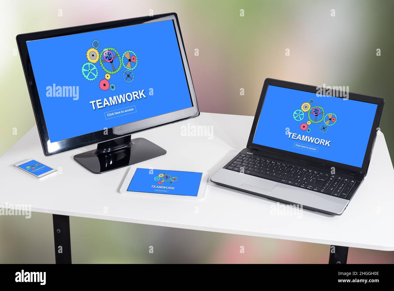 Teamwork concept shown on different information technology devices ...