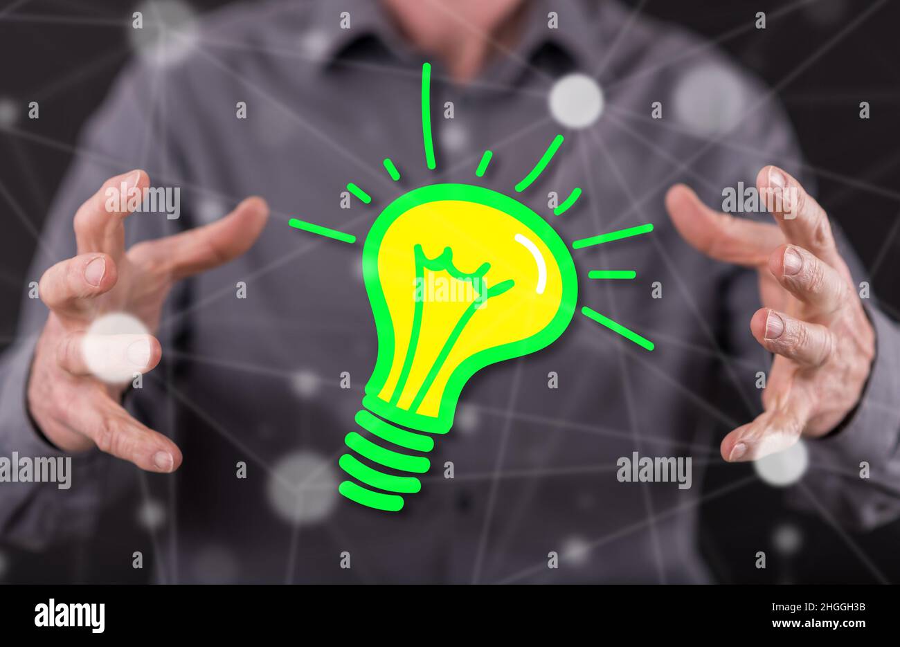 Green energy concept between hands of a man in background Stock Photo ...