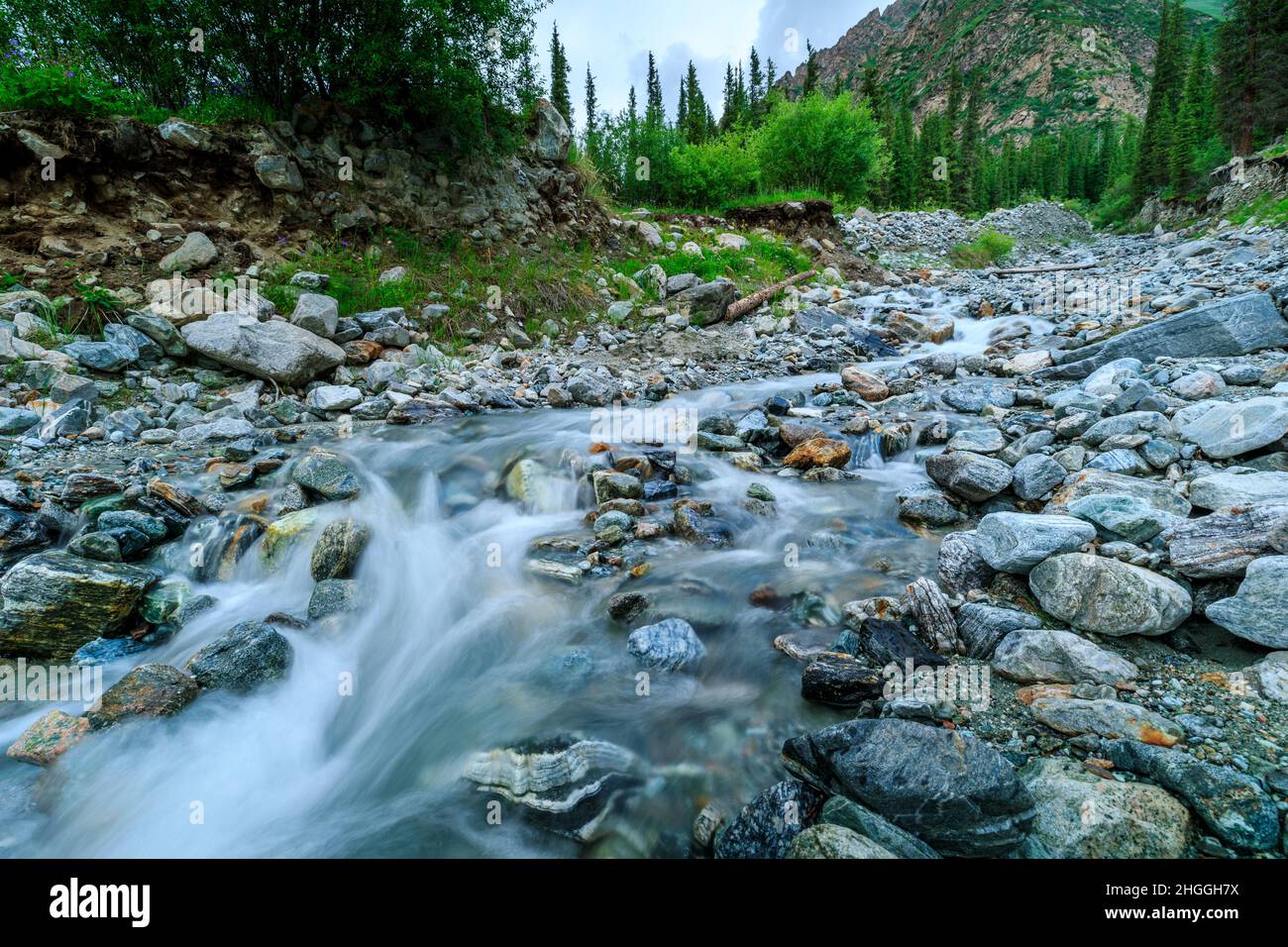 Clean spring water flowing down from the mountain Stock Photo - Alamy