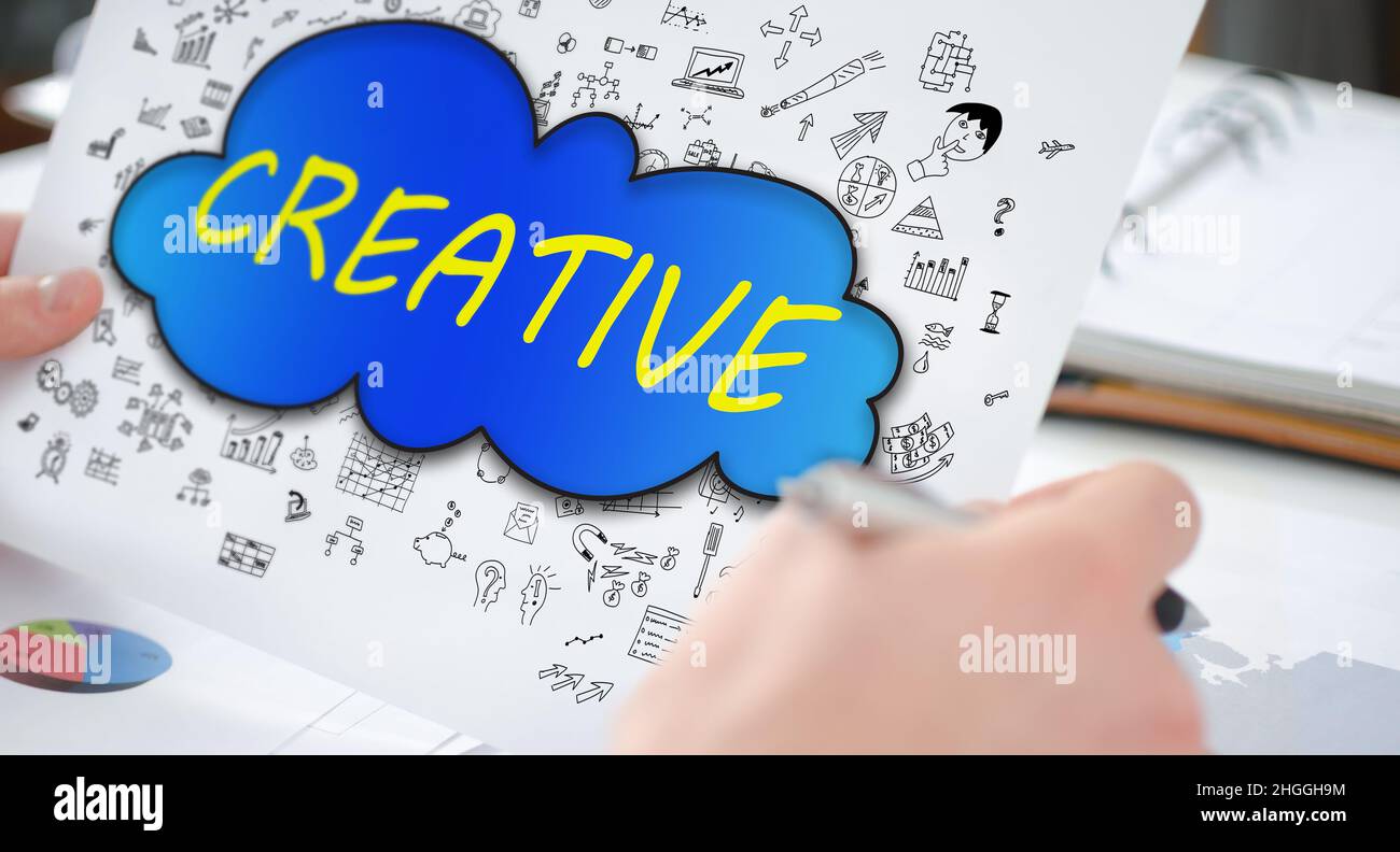 Hands holding a paper showing a creativity concept Stock Photo - Alamy