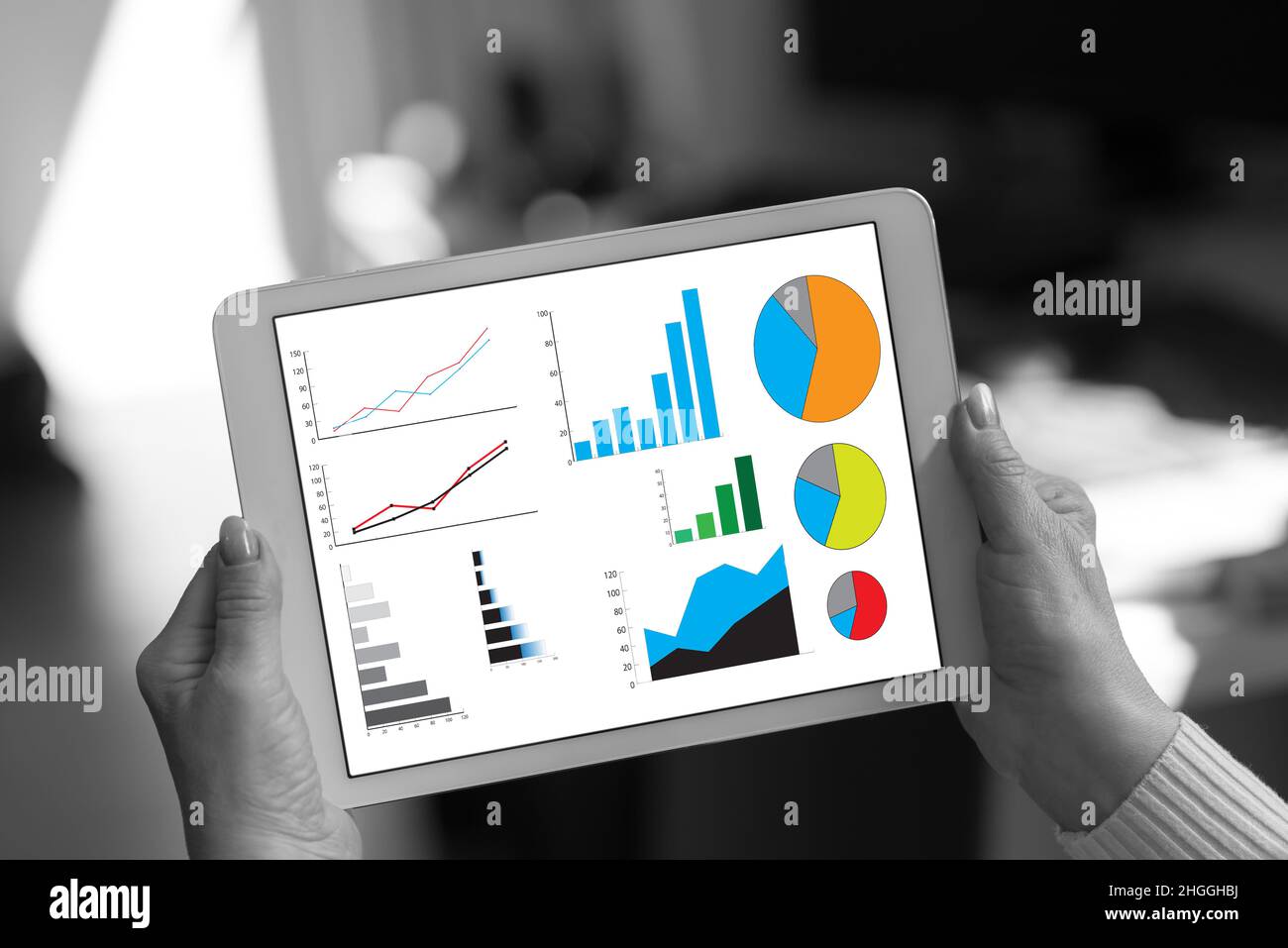 Graphical analysis concept shown on a tablet held by a woman Stock ...